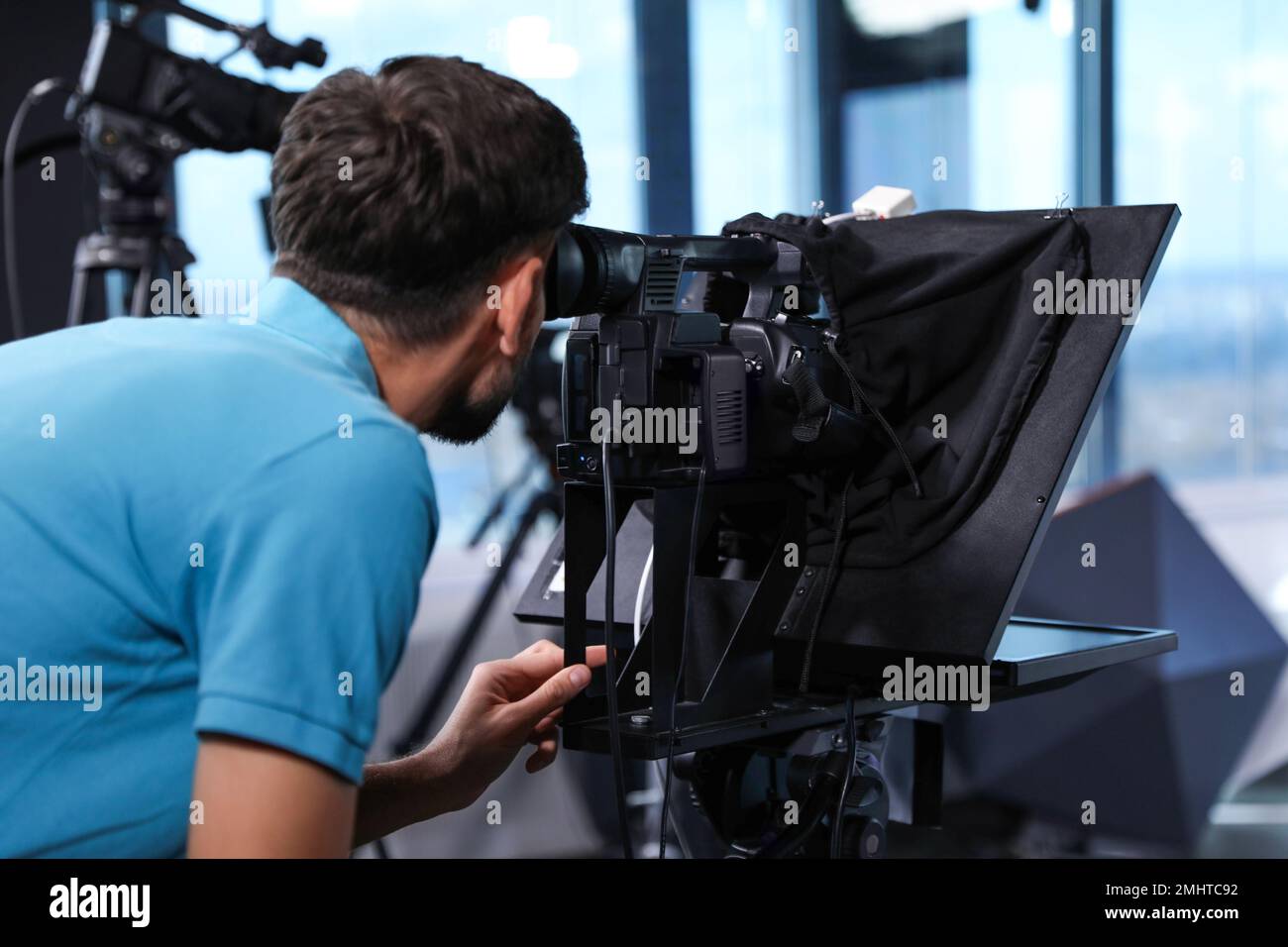 Professional video camera operator working in studio Stock Photo - Alamy