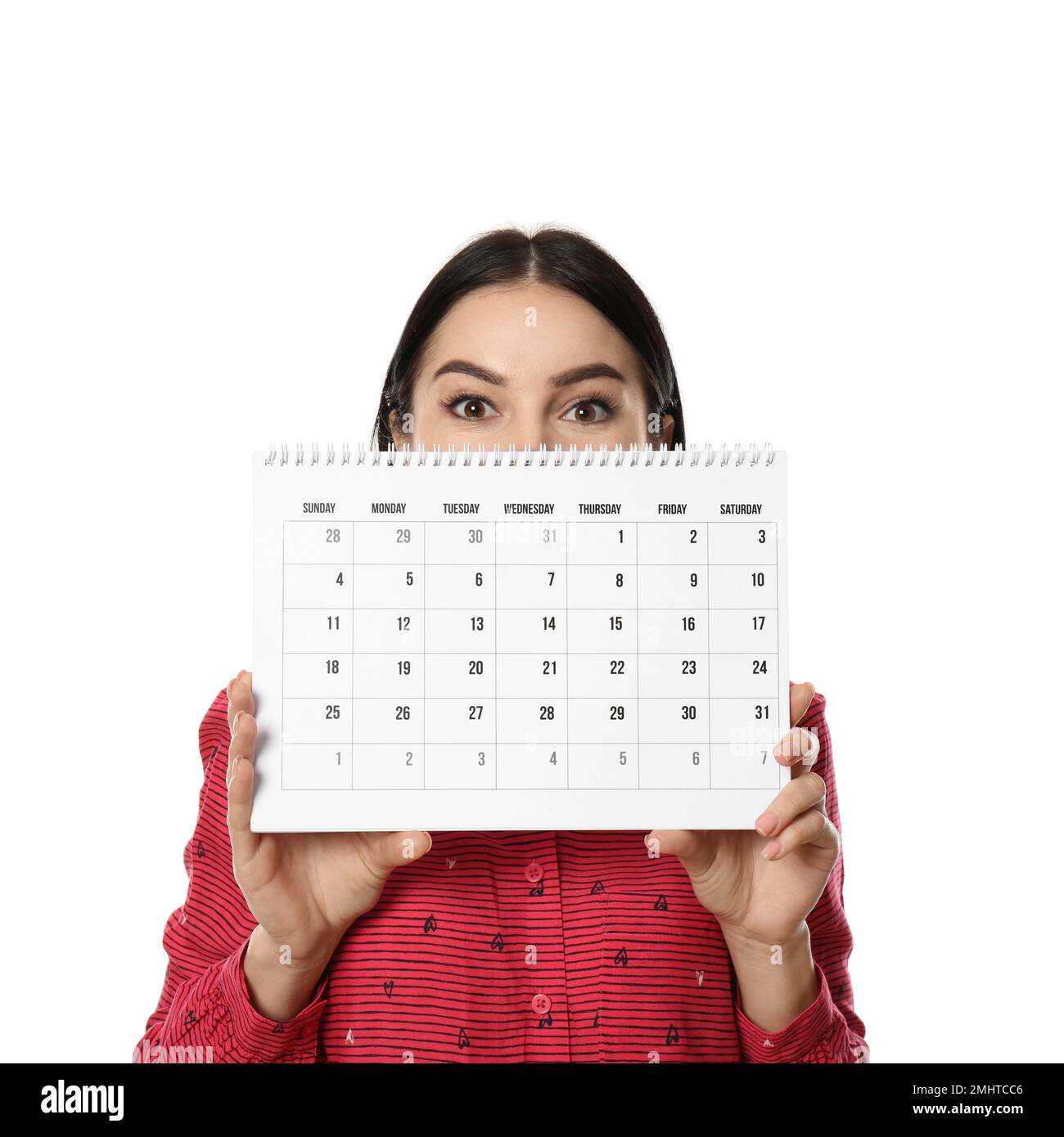 Young woman holding calendar with marked menstrual cycle days on white ...
