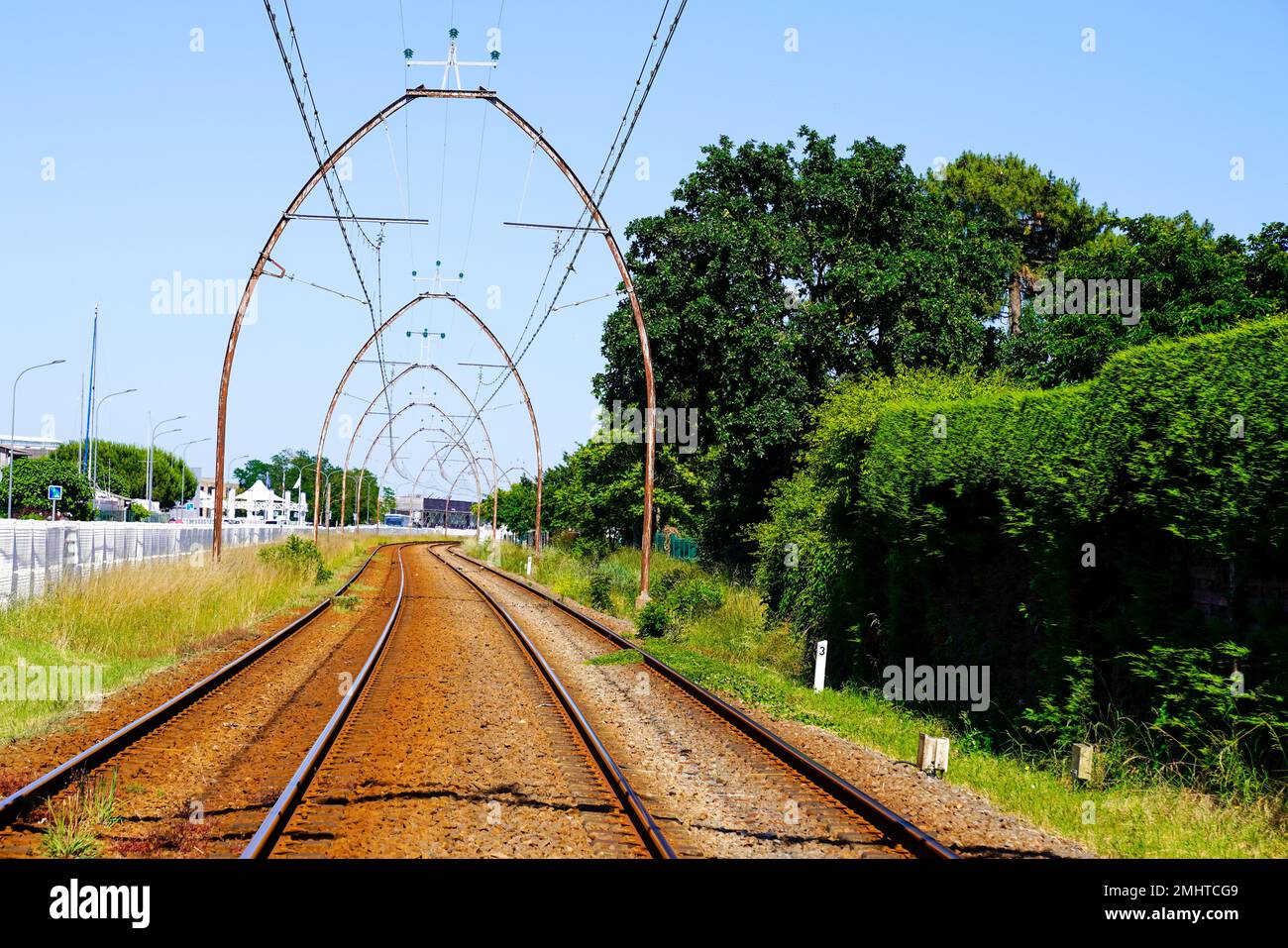 Railroad with electric arch for train track Stock Photo - Alamy