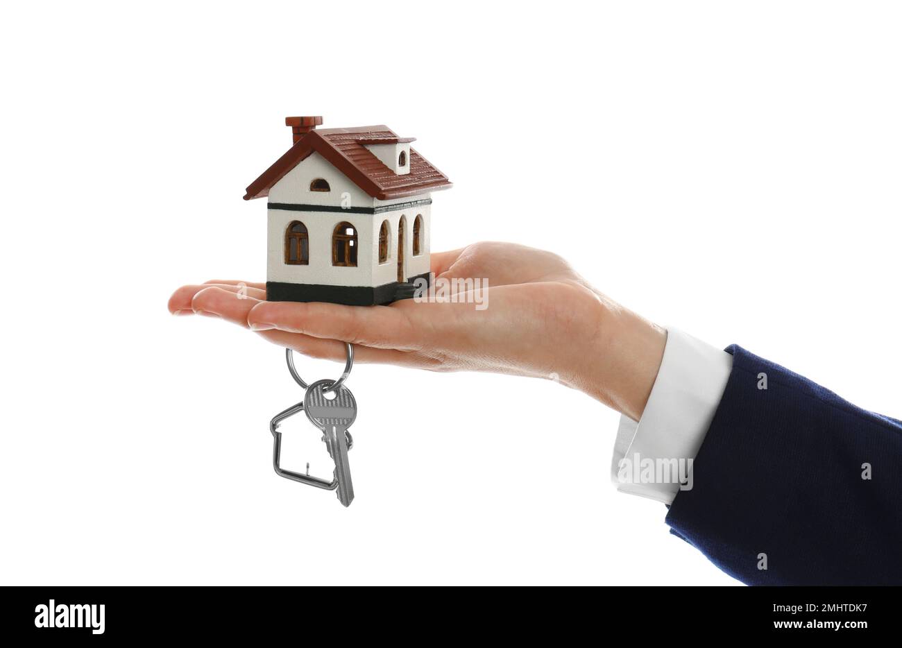 Real estate agent holding house model and key on white background ...