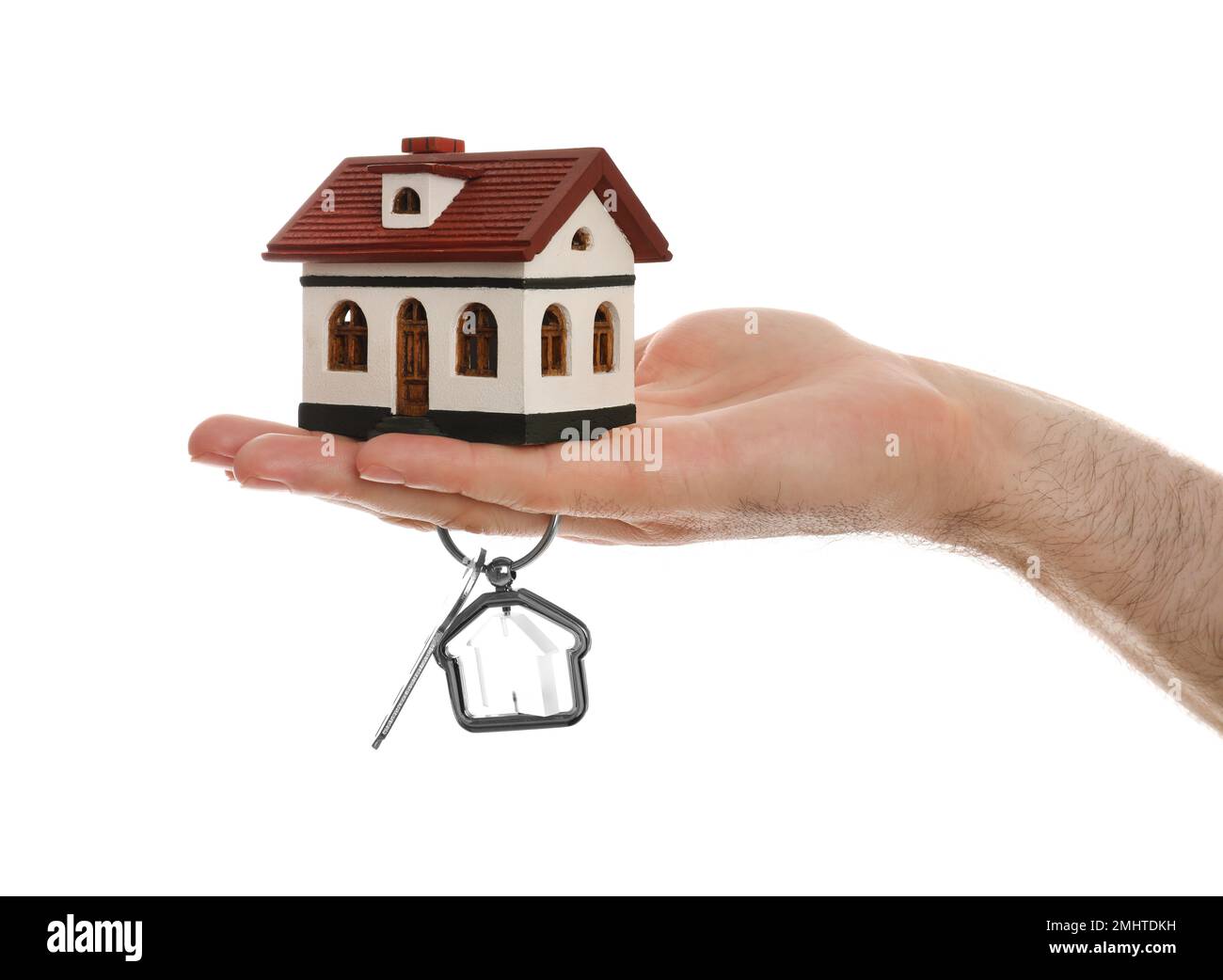 Real estate agent holding house model and key on white background ...