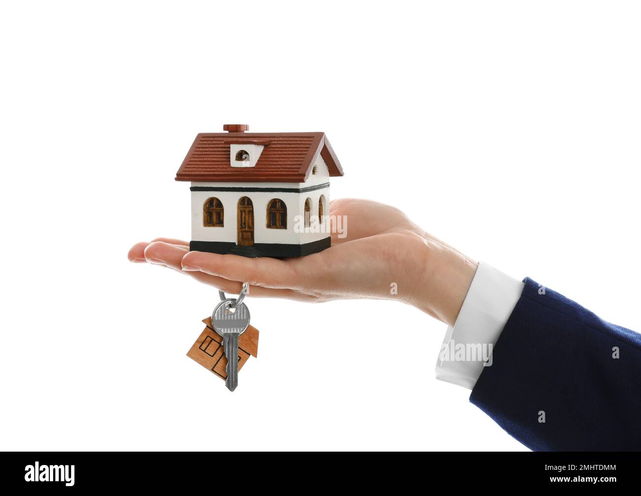 Real estate agent holding house model and key on white background ...