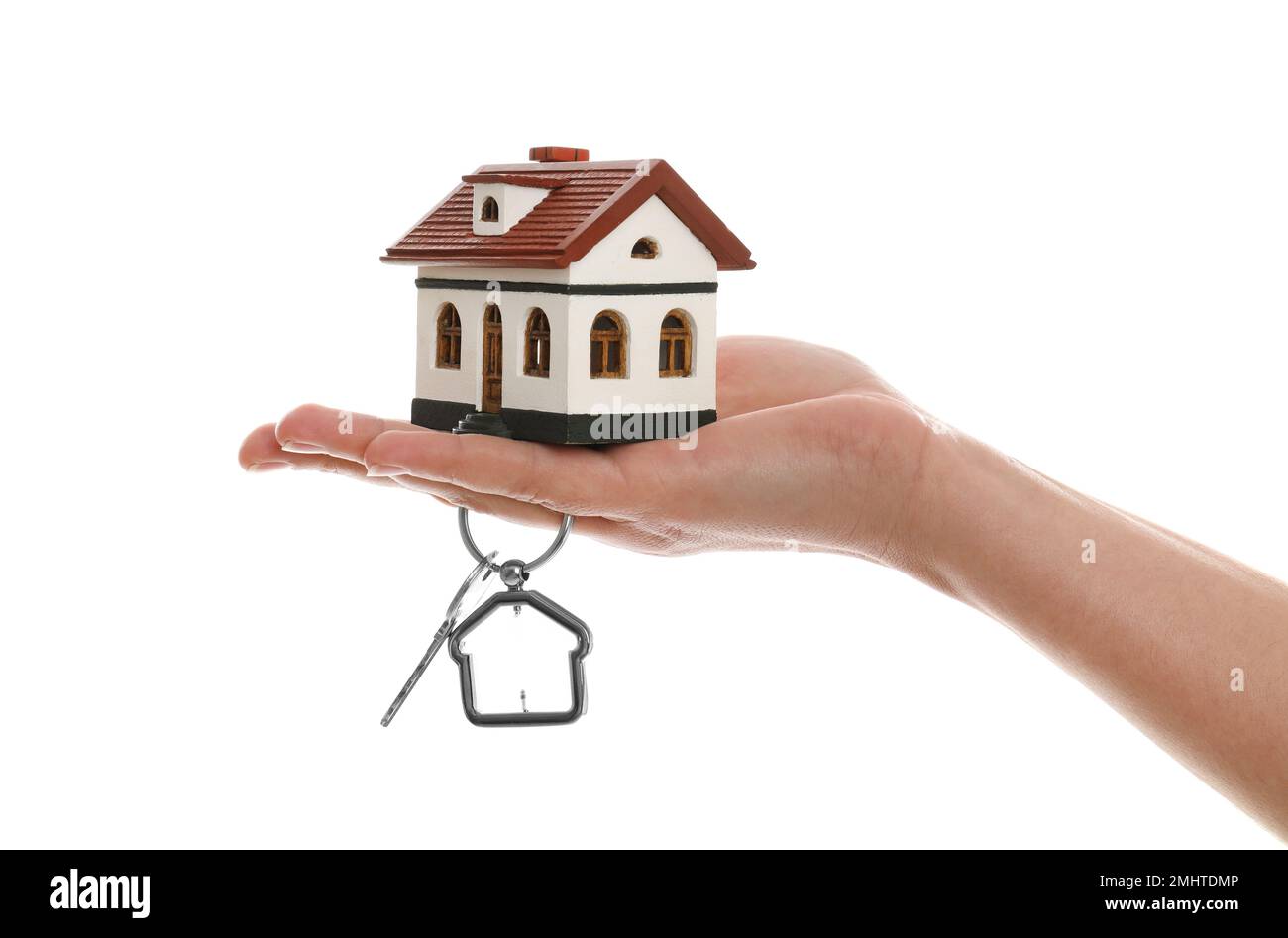 Real estate agent holding house model and key on white background ...