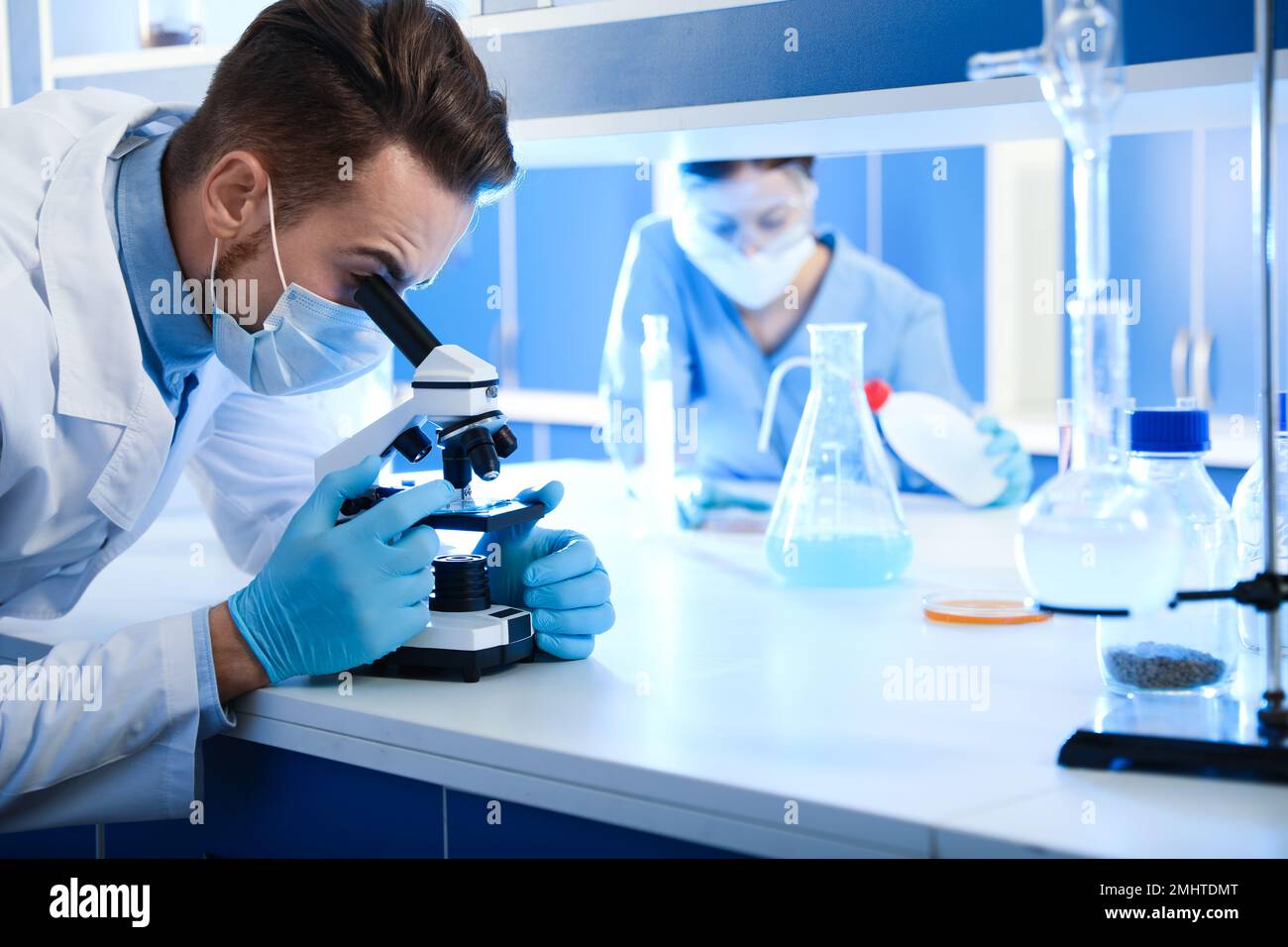 Scientist working with microscope indoors. Laboratory analysis Stock ...