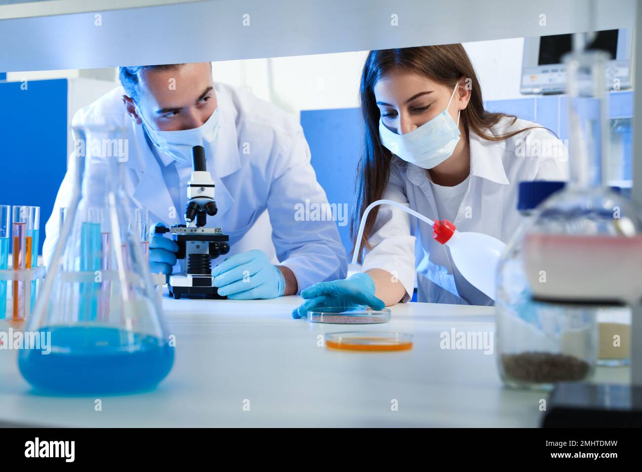 Scientists doing research and analysis with microscope in laboratory ...