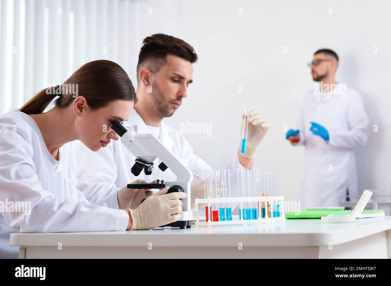 Medical students with microscope in modern laboratory Stock Photo - Alamy