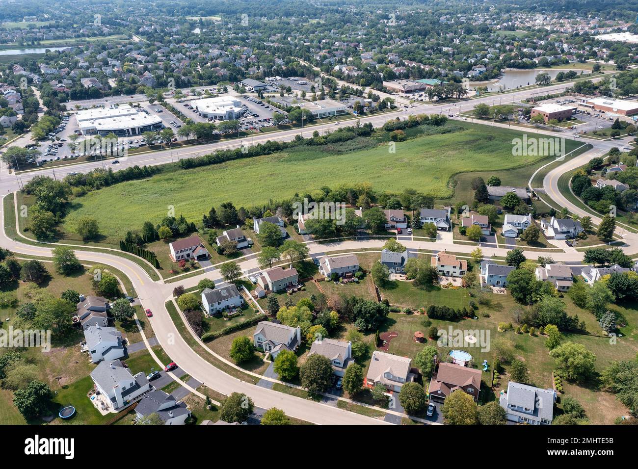A aerial showing a parcel of land for sale near a housing development ...