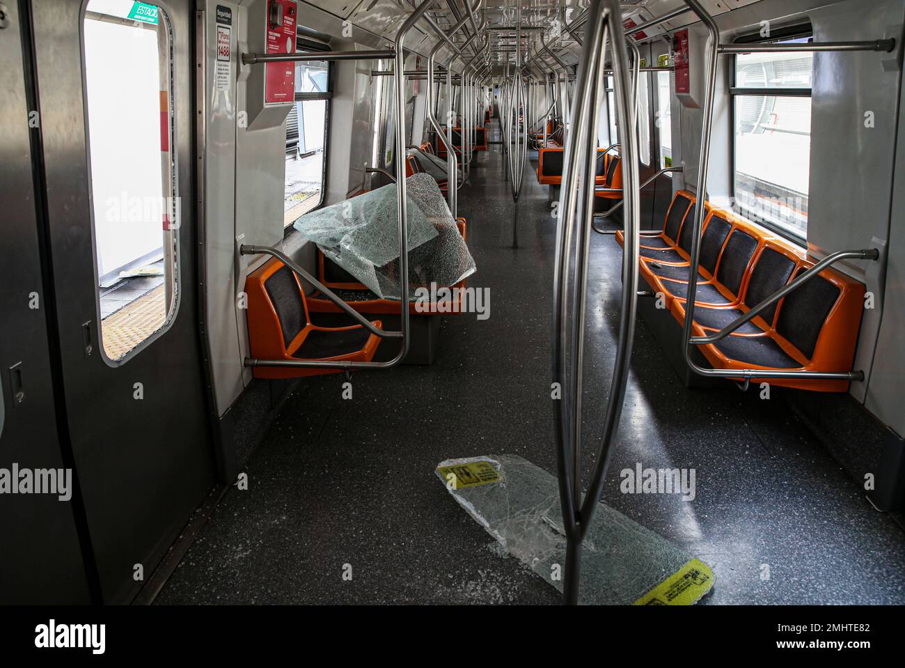The destroyed windows of a subway car lay on the floor during a protest ...