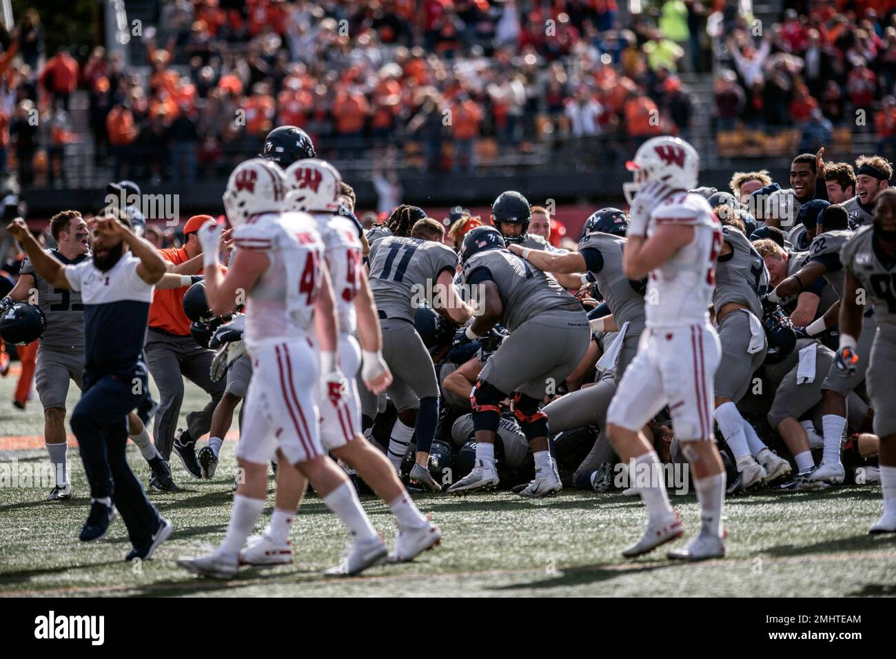 Wisconsin players walk off the field as Illinois celebrates their 24-21 ...