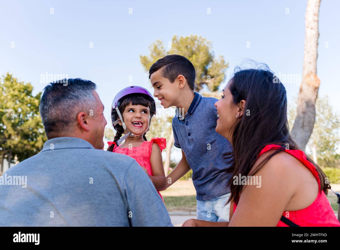 Couple with two young children having fun outside Stock Photo - Alamy
