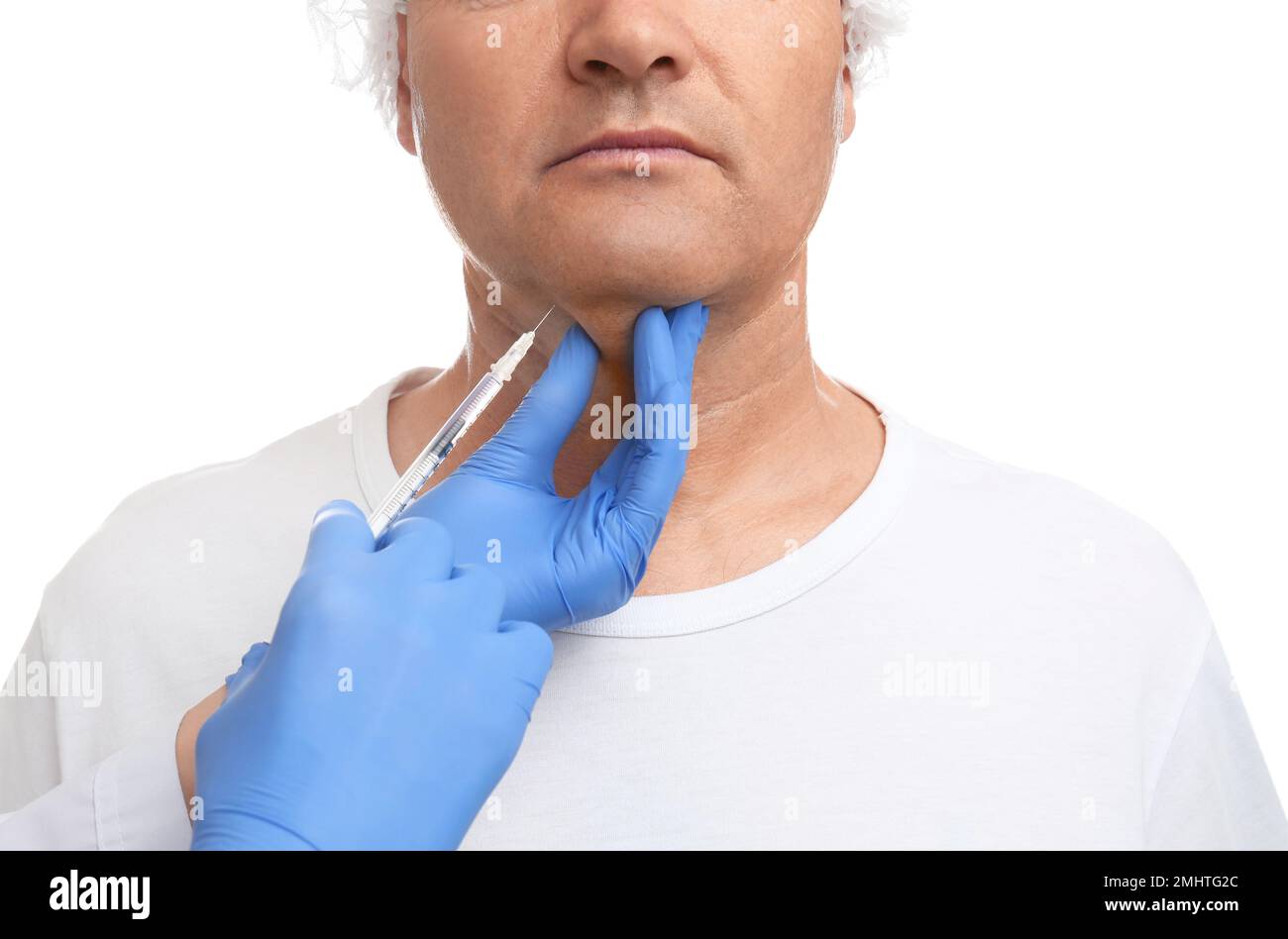 Mature man with double chin receiving injection on white background ...