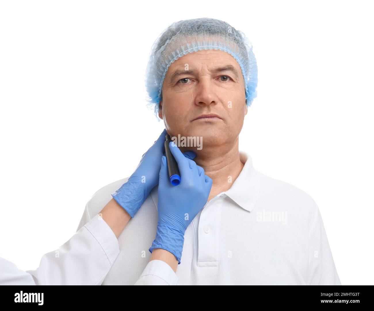 Surgeon with marker preparing man for operation against white ...