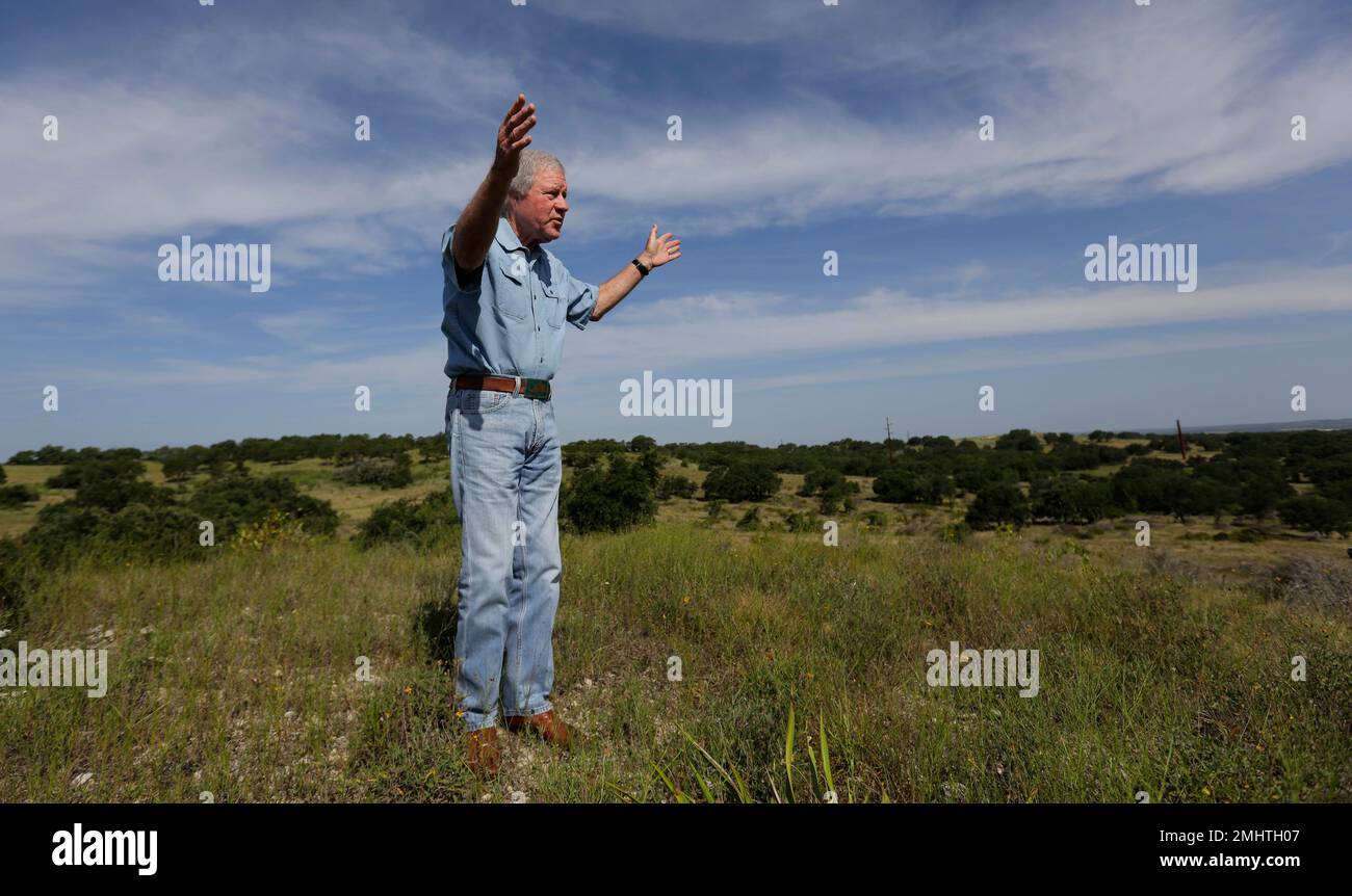 Andy Sansom walks on his property as he talks about a proposed new ...