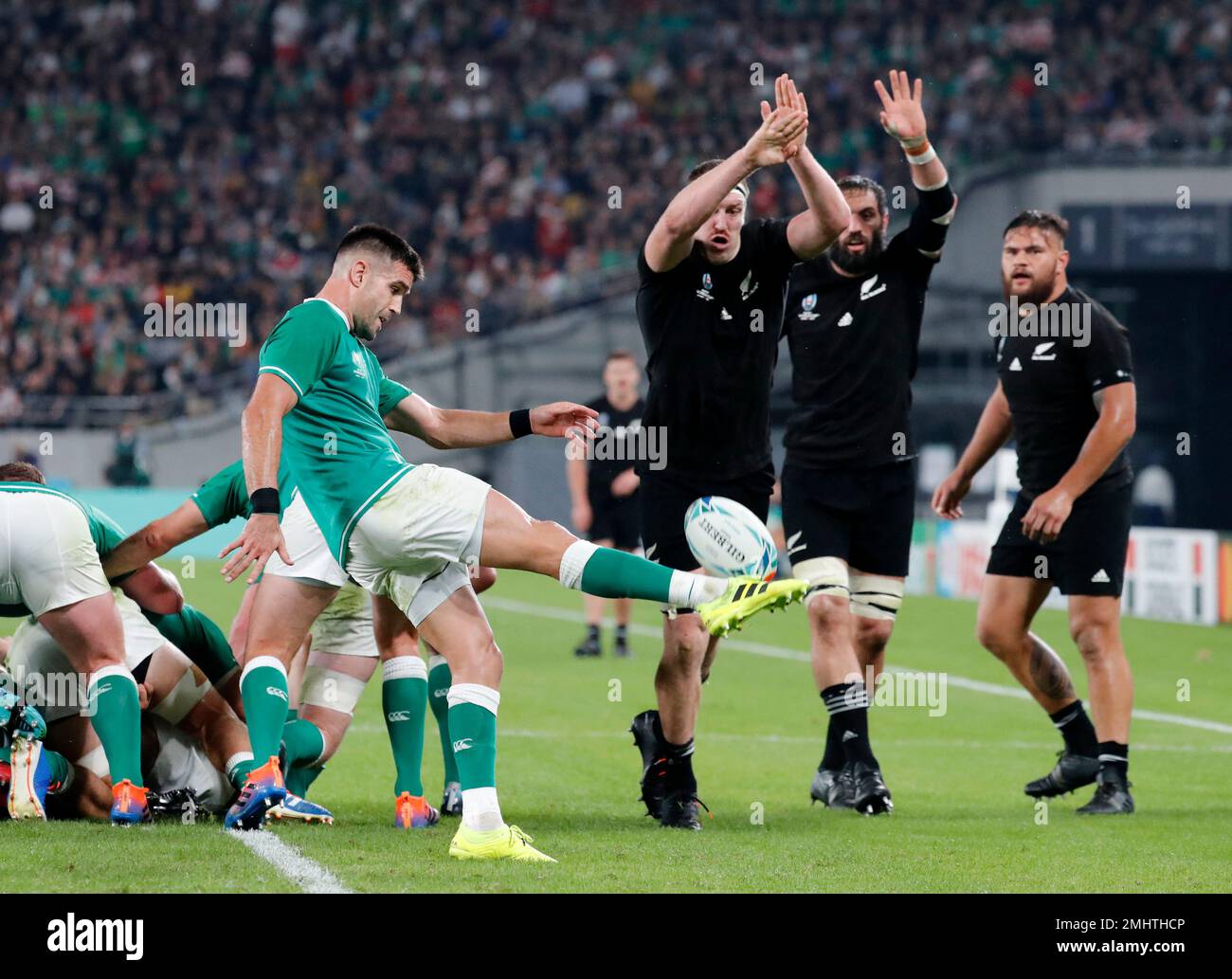 Ireland's Conor Murray kicks the ball against New Zealand's defense ...