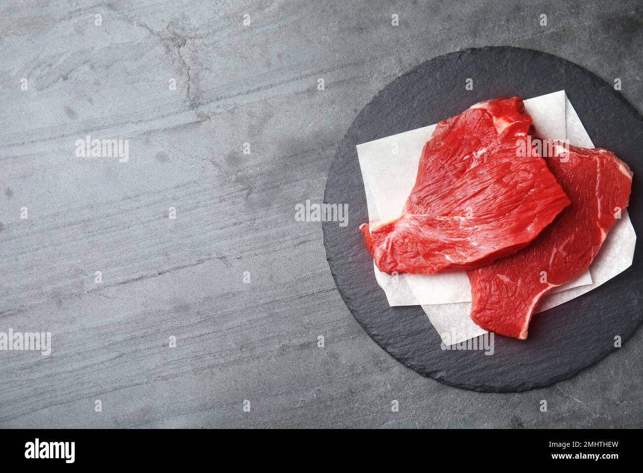 Fresh raw beef cut on grey table, top view. Space for text Stock Photo ...