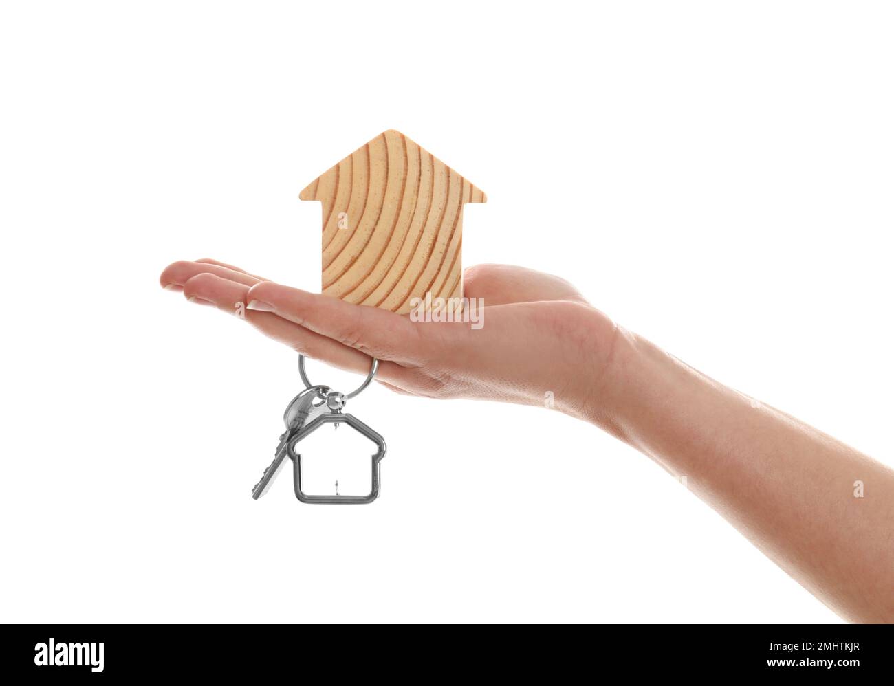 Real estate agent holding house figure and key on white background ...
