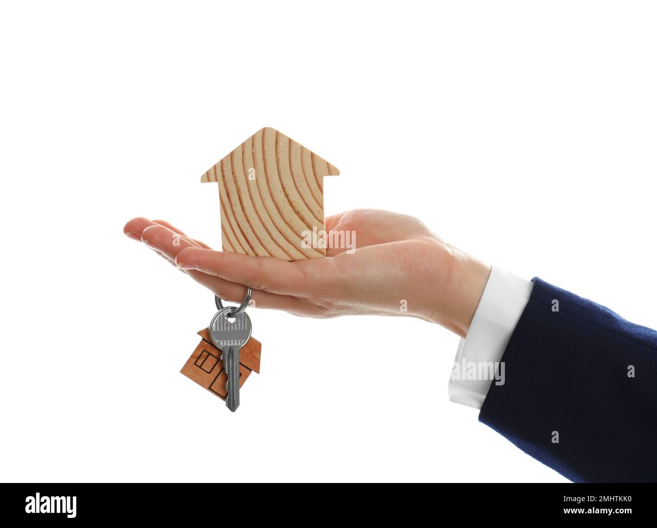 Real estate agent holding house figure and key on white background ...