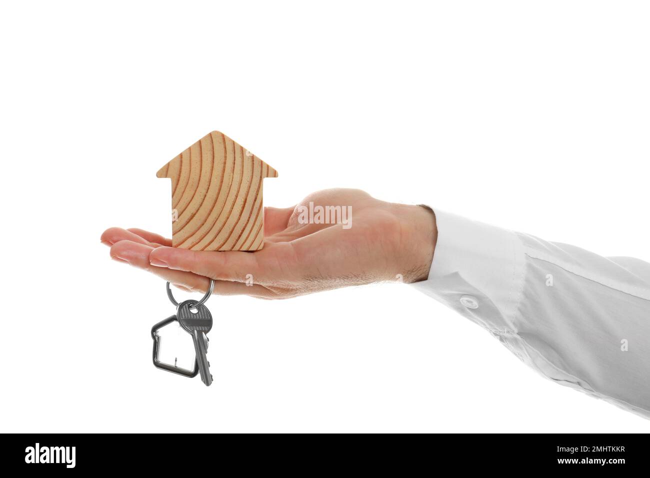 Real estate agent holding house figure and key on white background ...
