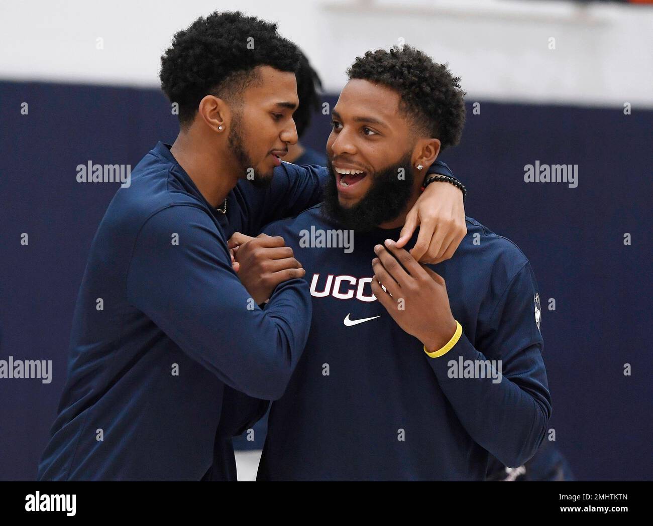 Connecticut's Jalen Gaffney, left, and R.J. Cole, right, share a moment ...