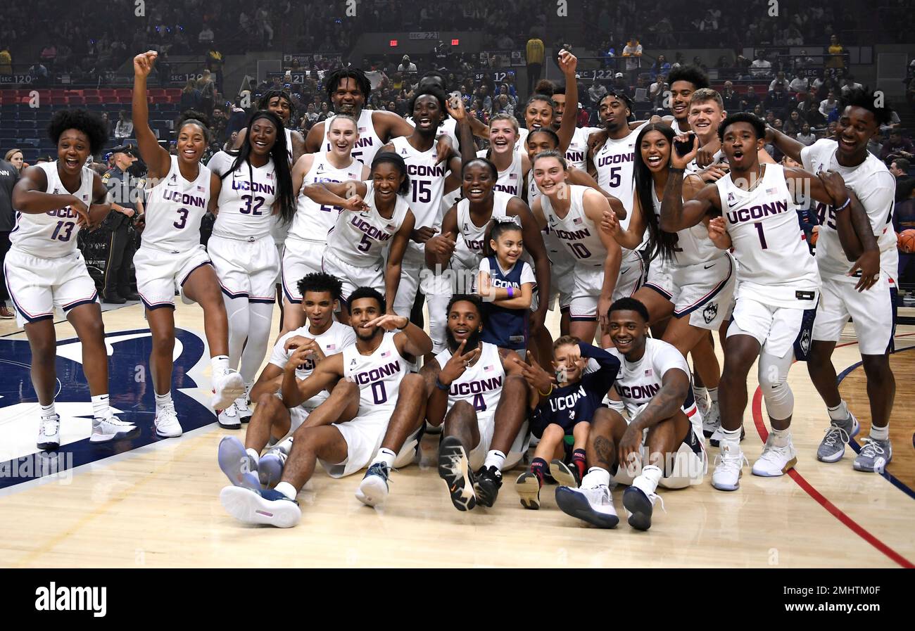 Connecticut men's and women's team and others pose together for a photo ...