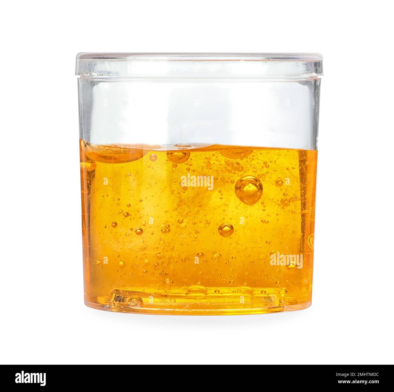 Orange slime in plastic container isolated on white. Antistress toy ...