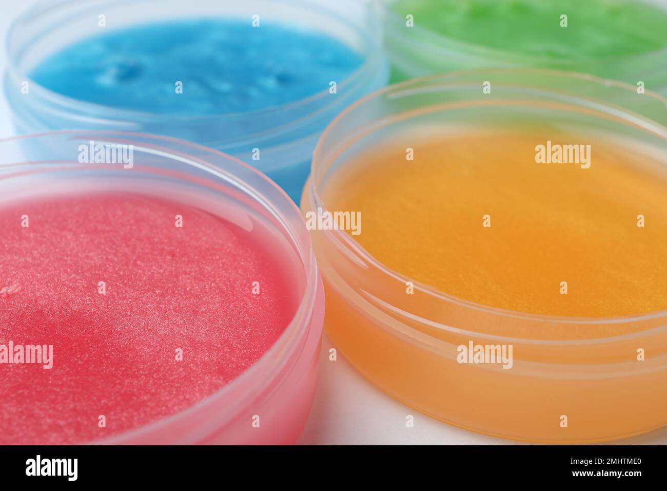 Colorful slimes in plastic containers, closeup. Antistress toy Stock ...