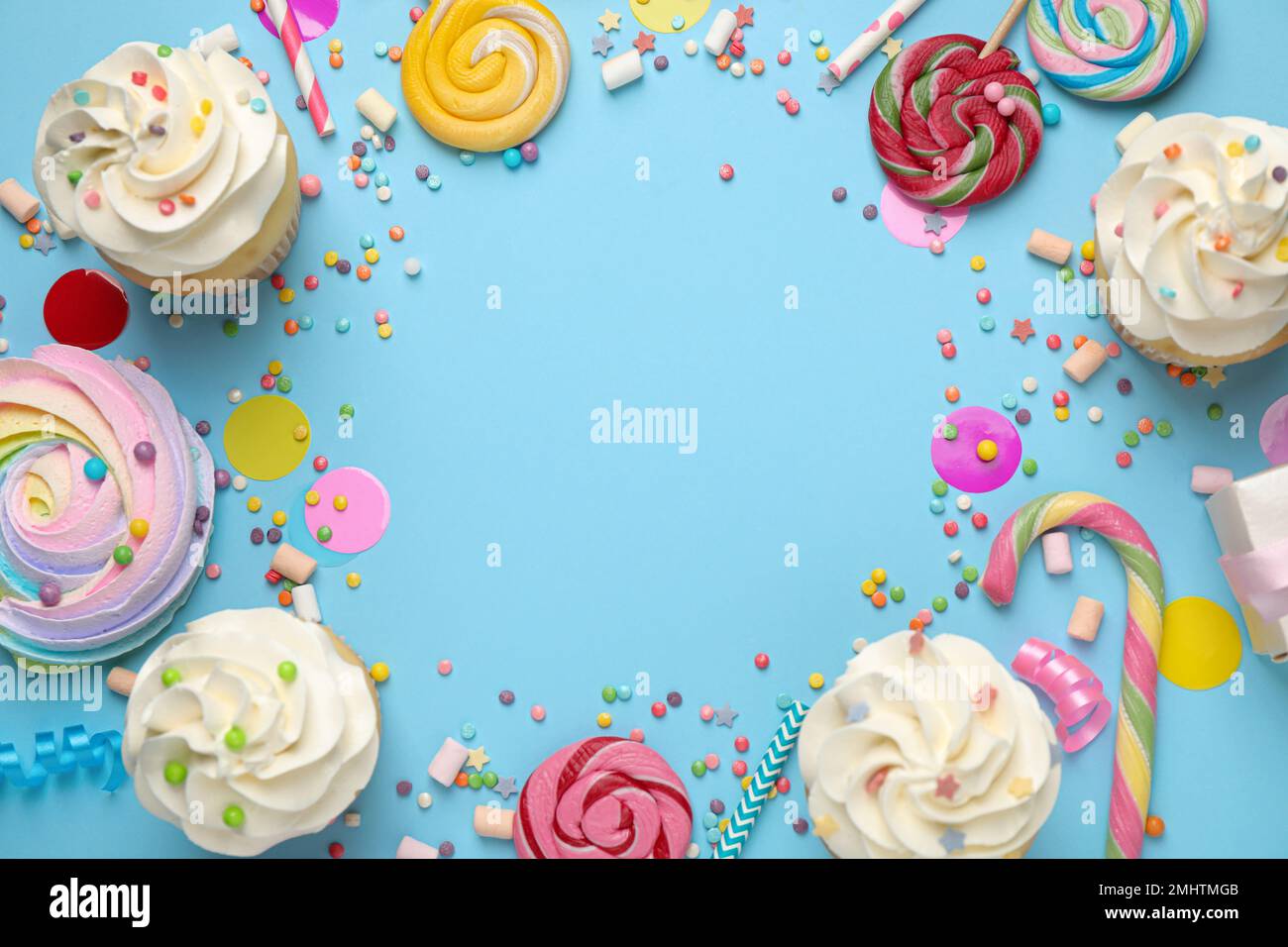 Flat lay composition with cupcakes on light blue background, space for ...