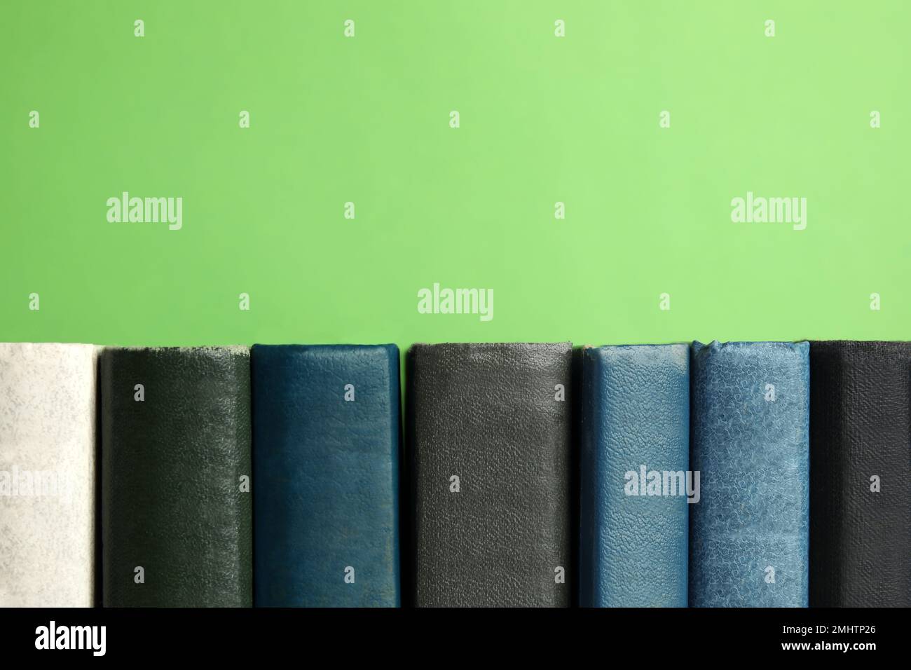 Collection of old books on green background, space for text Stock Photo ...