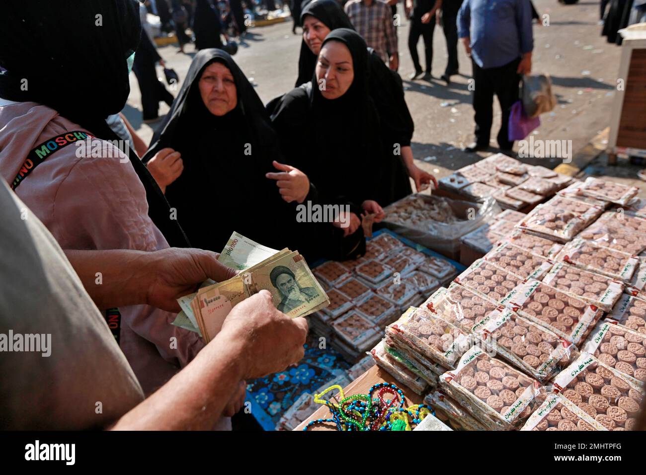 Iranian Shiite pilgrims shop for religious items outside the holy ...