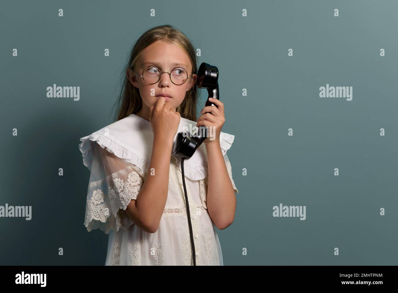 Strange call. Portrait of a girl listening to the phone. Retro style ...