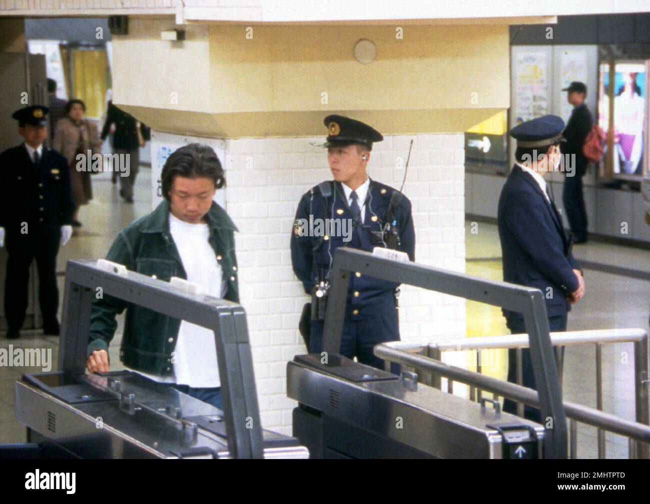 Police officers keep watchful eyes near one of the ticket barriers at ...