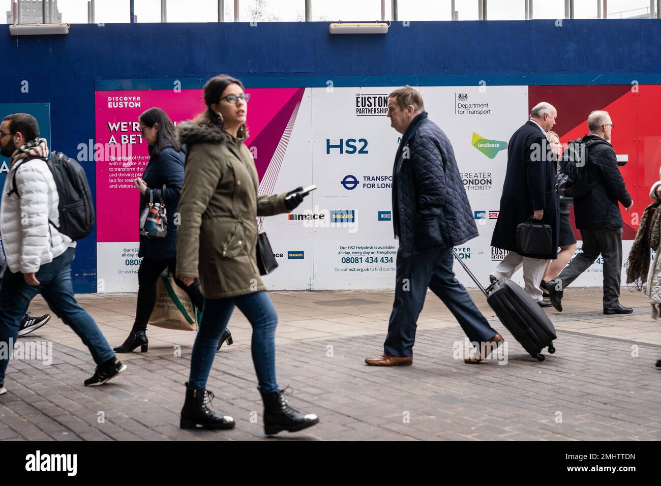 Members of the public walk past HS2 signage near to the proposed site ...