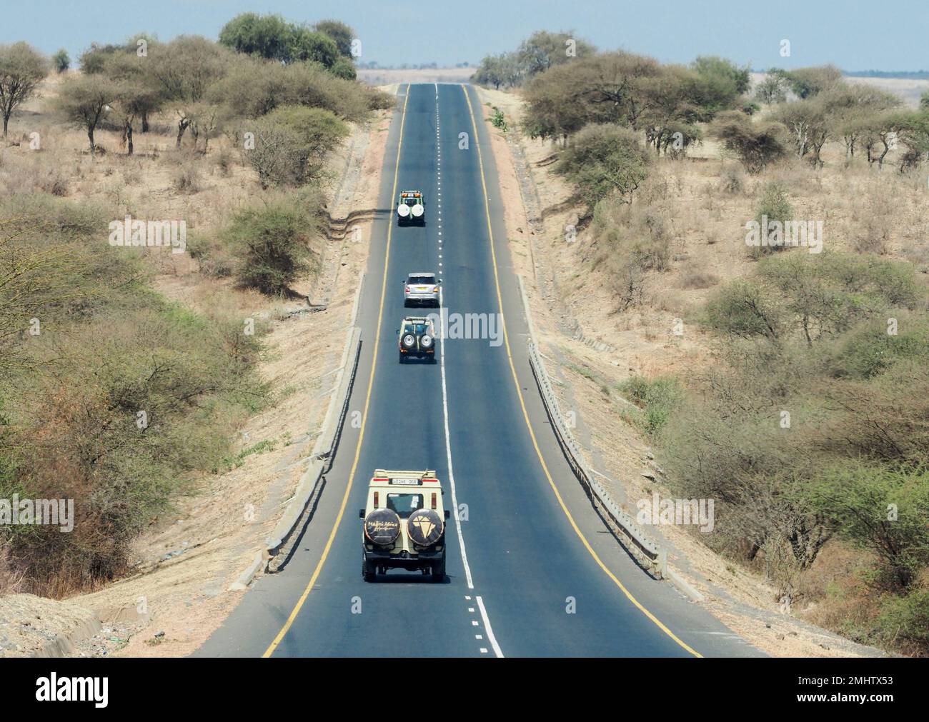 Nanja, Tanzania. 21st Sep, 2022. Cars drive on a straight two-lane road ...