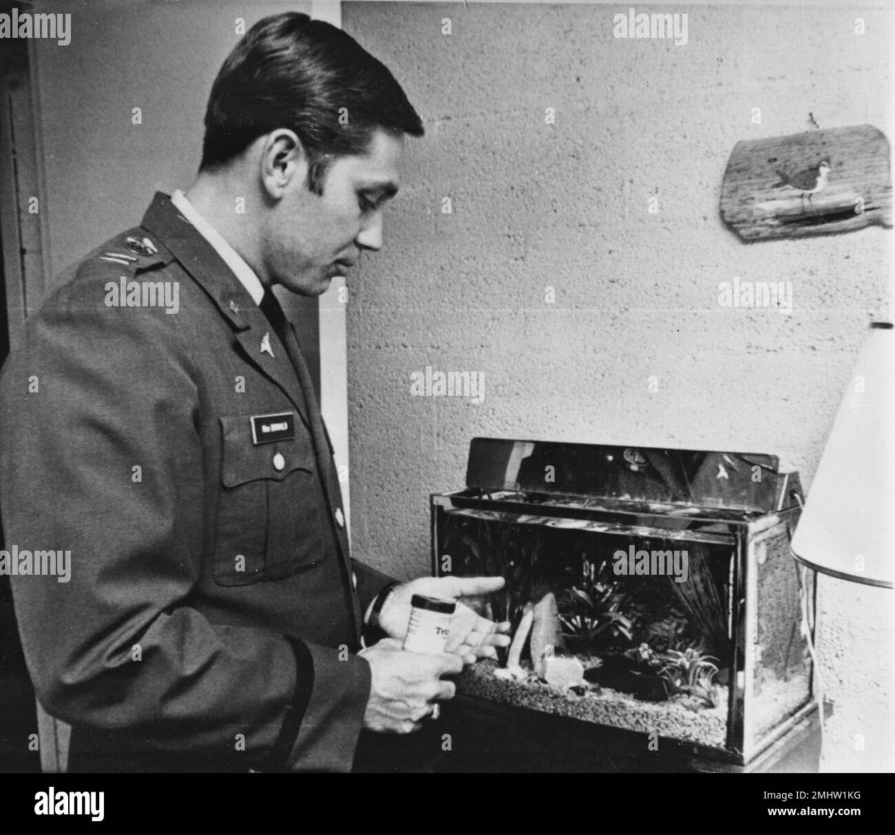 Capt. Jeffrey MacDonald feeds his tropical fish in his Bachelor Officer ...