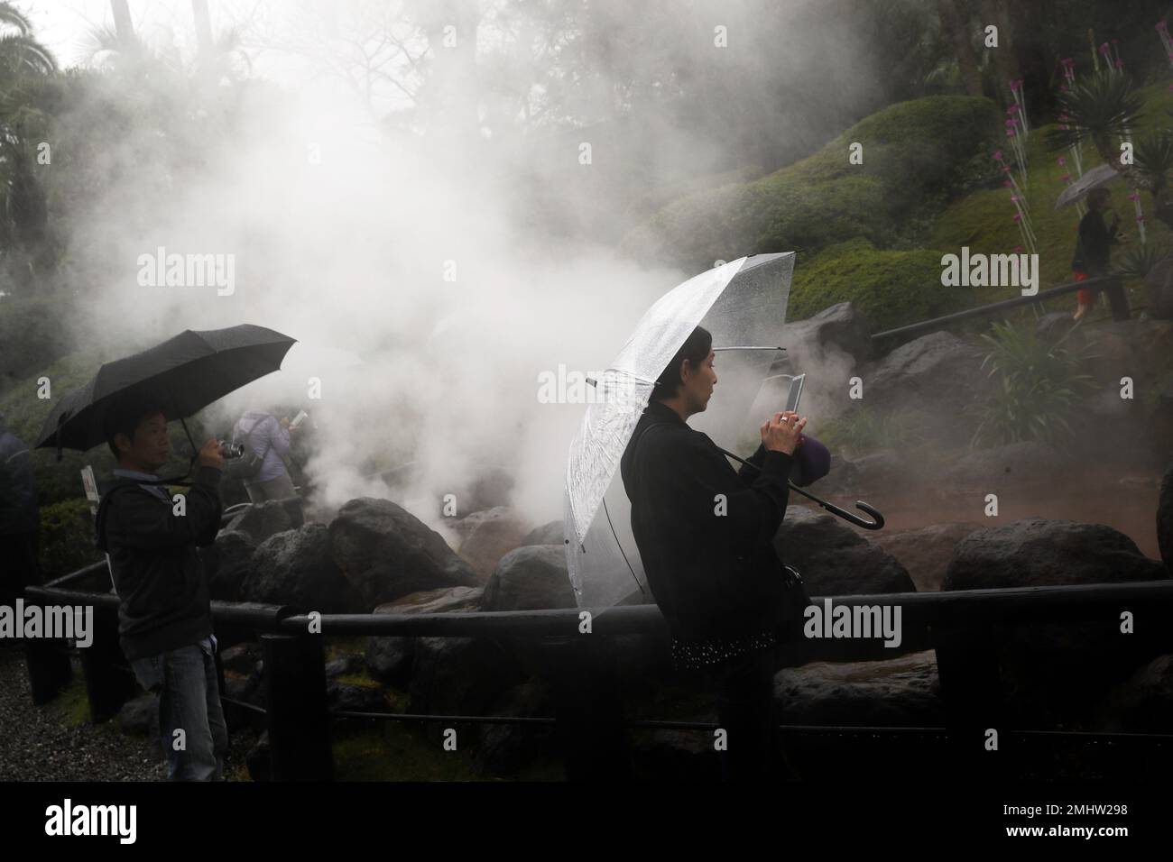 Visitors take photos as they visit the hot springs in Beppu, Japan ...
