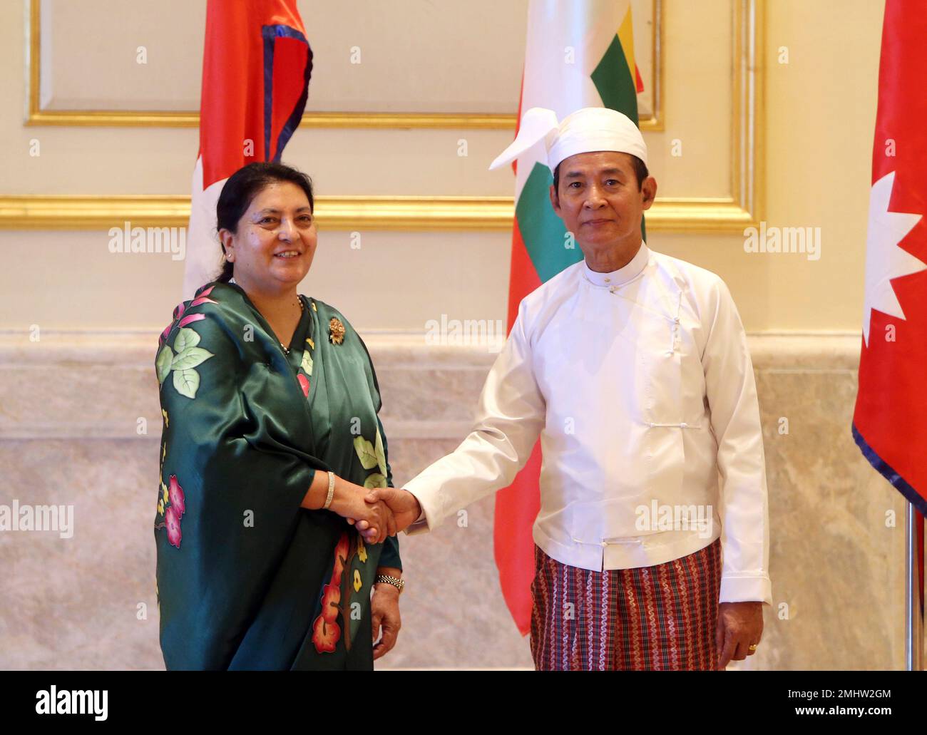 Myanmar's President Win Myint, right, shakes hands with Nepali ...
