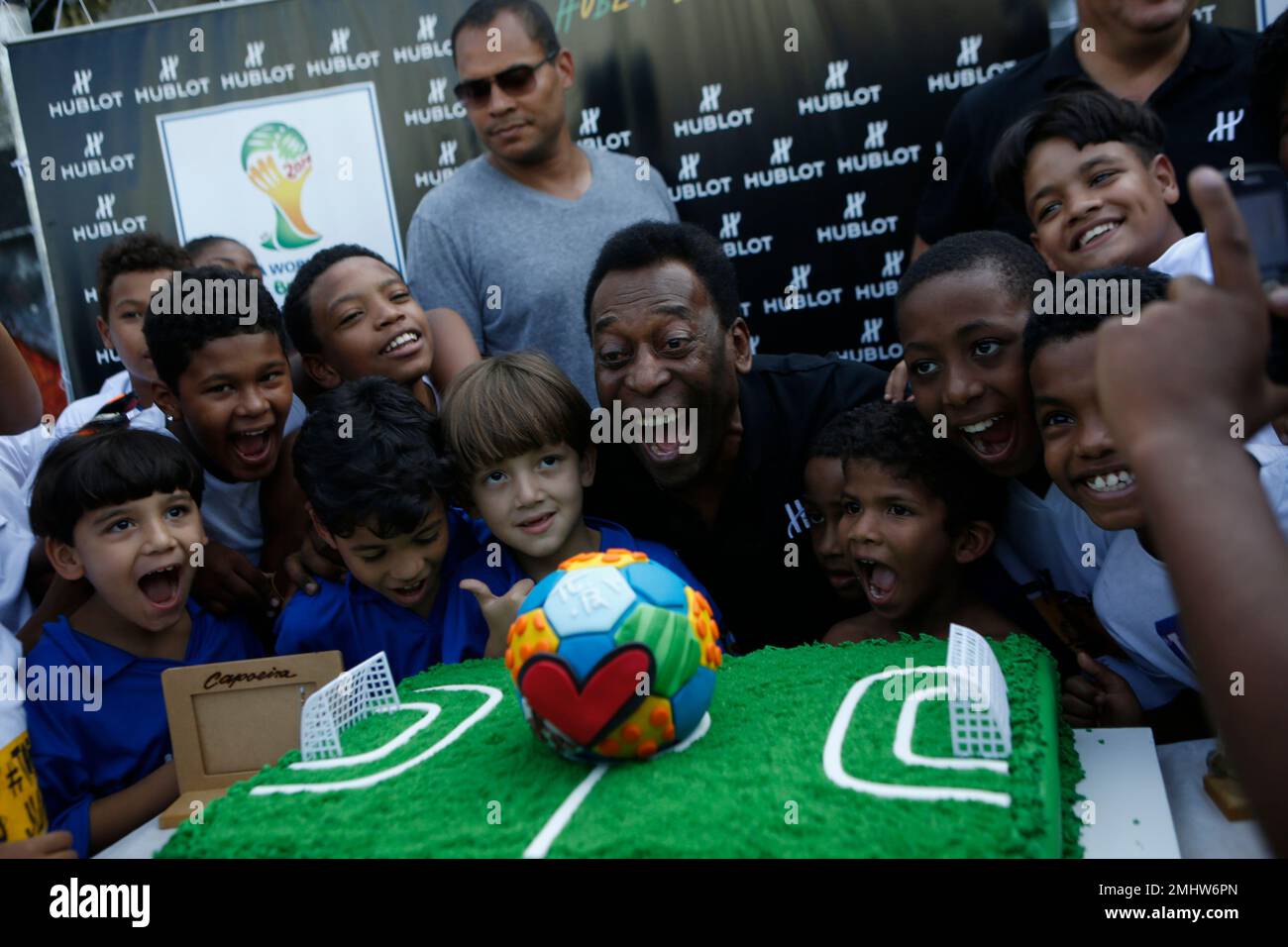 DISTRIBUTED FOR HUBLOT - Soccer star Pele shares a moment with children ...