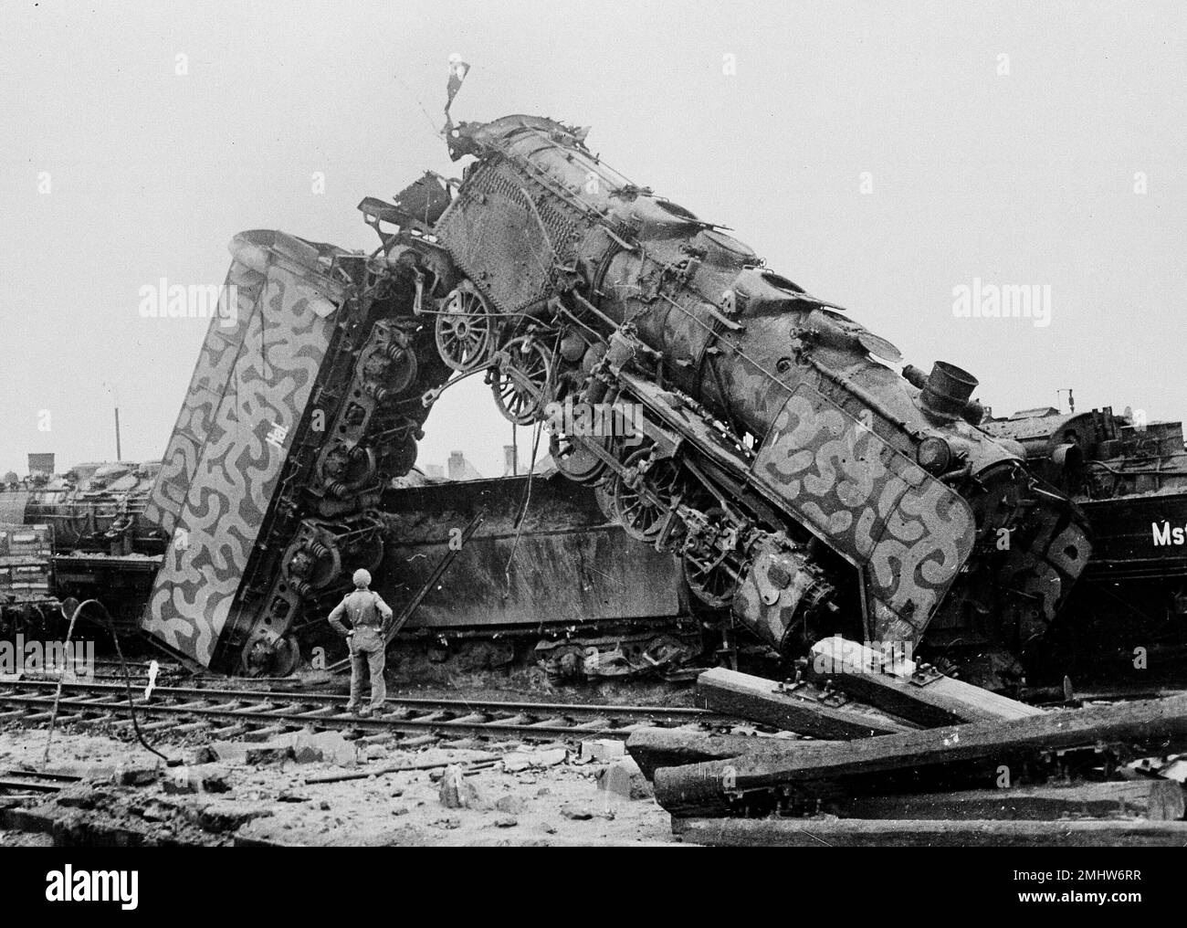 German locomotive is upended as a result of Allied bombing of railway ...