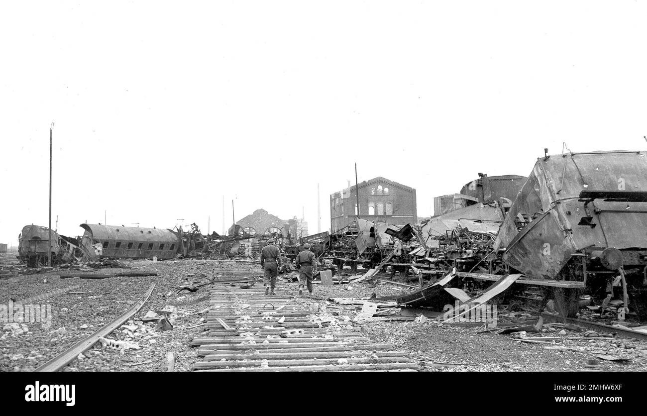 Canadian soldiers passing through the wreckage of the important railway ...