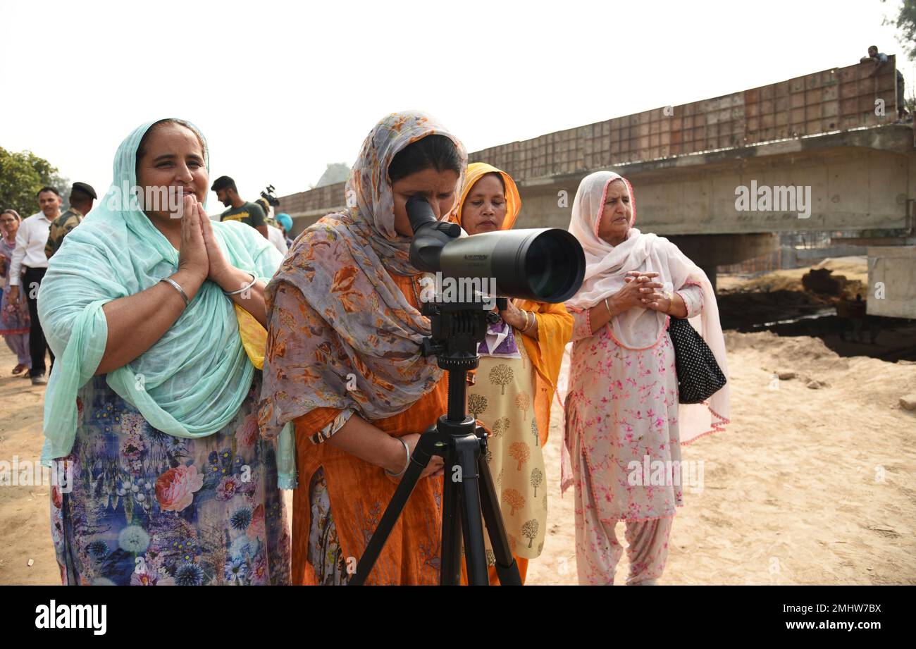Indian Sikh women fold their hands in respect as they look towards ...