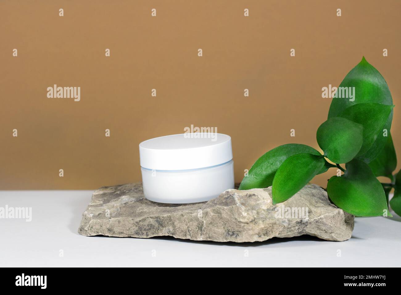 A mock up white jar of cream on a natural stone podium pedestal, on a ...