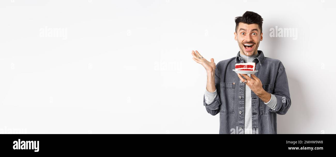 Excited man celebrating birthday, looking happy, holding cake with ...
