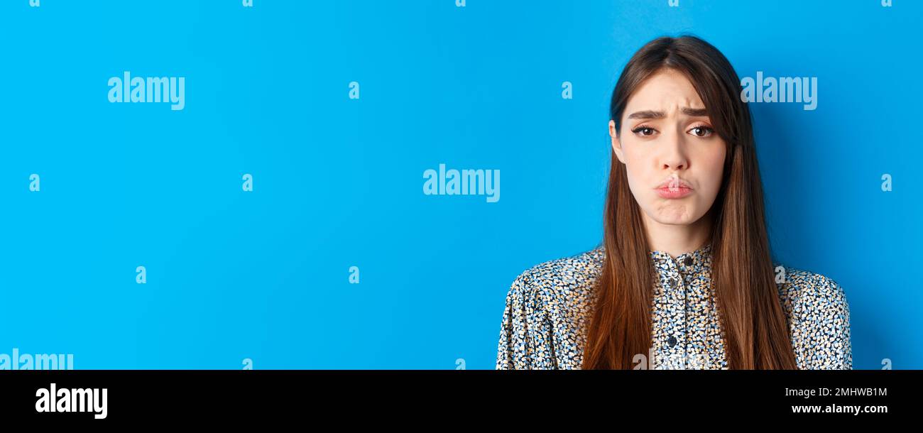 People emotions concept. Sad cute girl begging for something, pucker ...