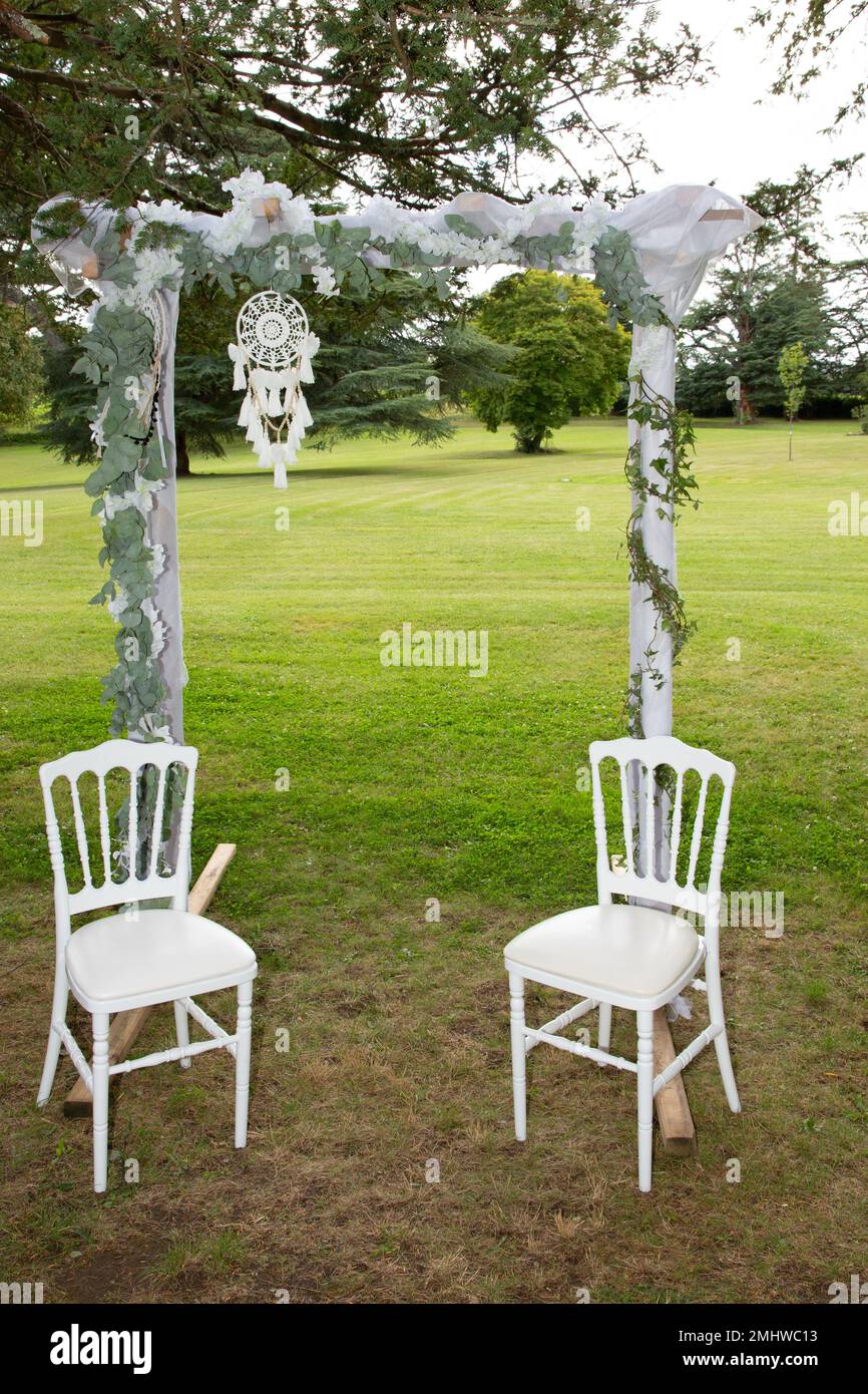 bride and groom white seat chair in summer wedding arch decorated for ...