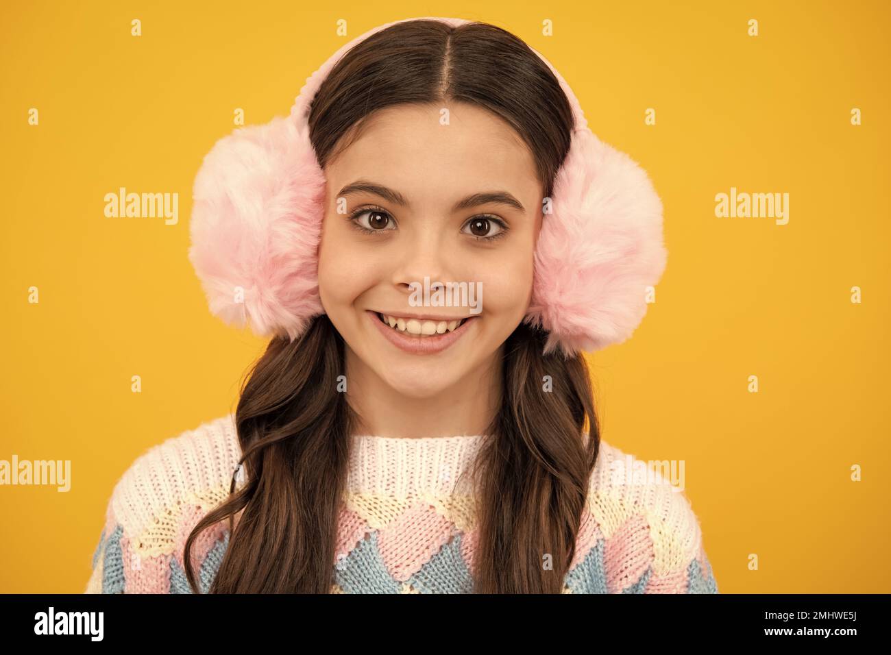 Beautiful teen girl in a winter warm earmuff ear-flaps hat and a warm ...