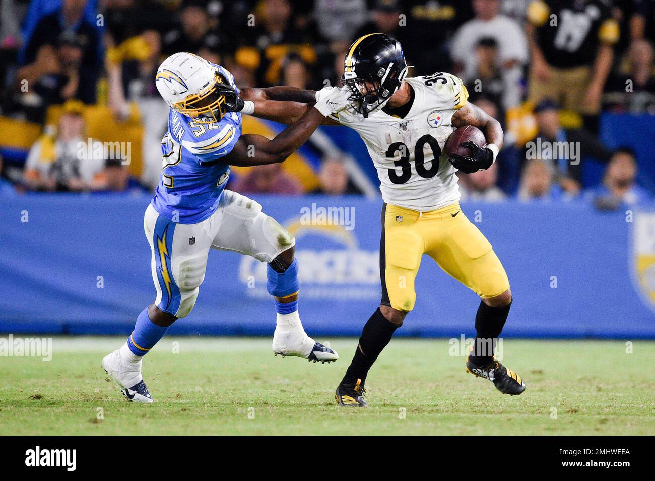 Pittsburgh Steelers running back James Conner, right, runs while Los ...