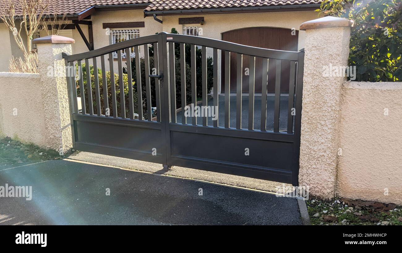 modern steel grey gate aluminum portal with blades in sunny flare day ...
