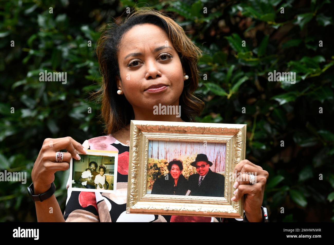 In this Sept. 6, 2019, photo, Donna Cryer holds up family photos that ...