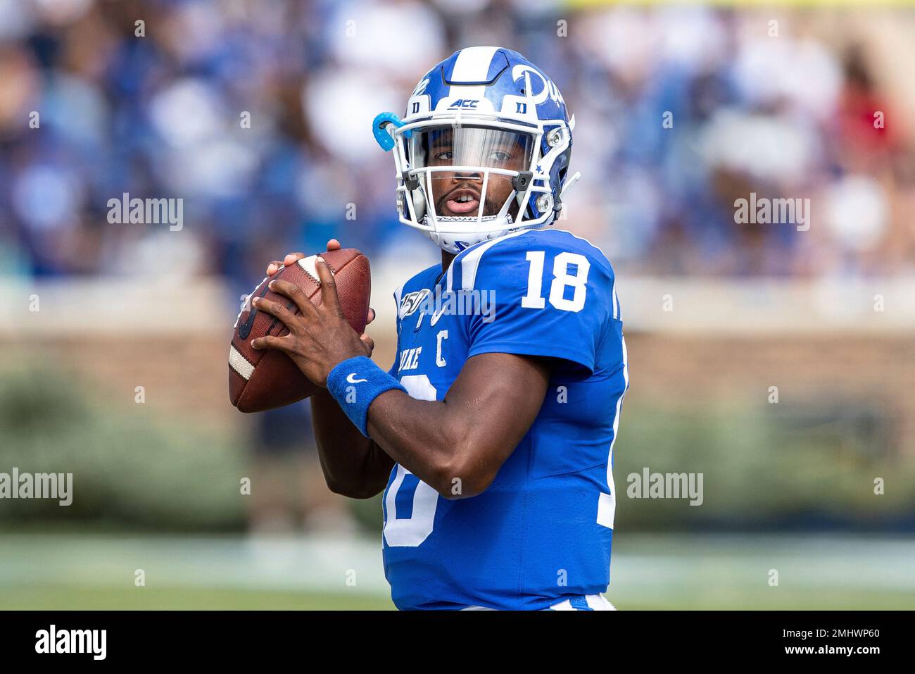 Duke's Quentin Harris stays warm by throwing passes during a stoppage ...