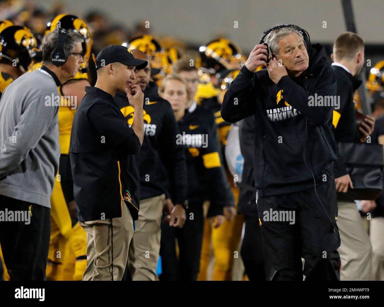 Iowa head coach Kirk Ferentz adjusts his headset during the first half ... Iowa head coach Kirk Ferentz adjusts his headset during the first half ...
